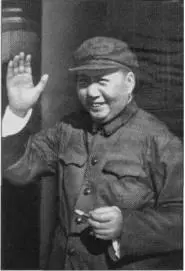 In the photo, Chairman Mao is smiling, raising his hand to greet the ...